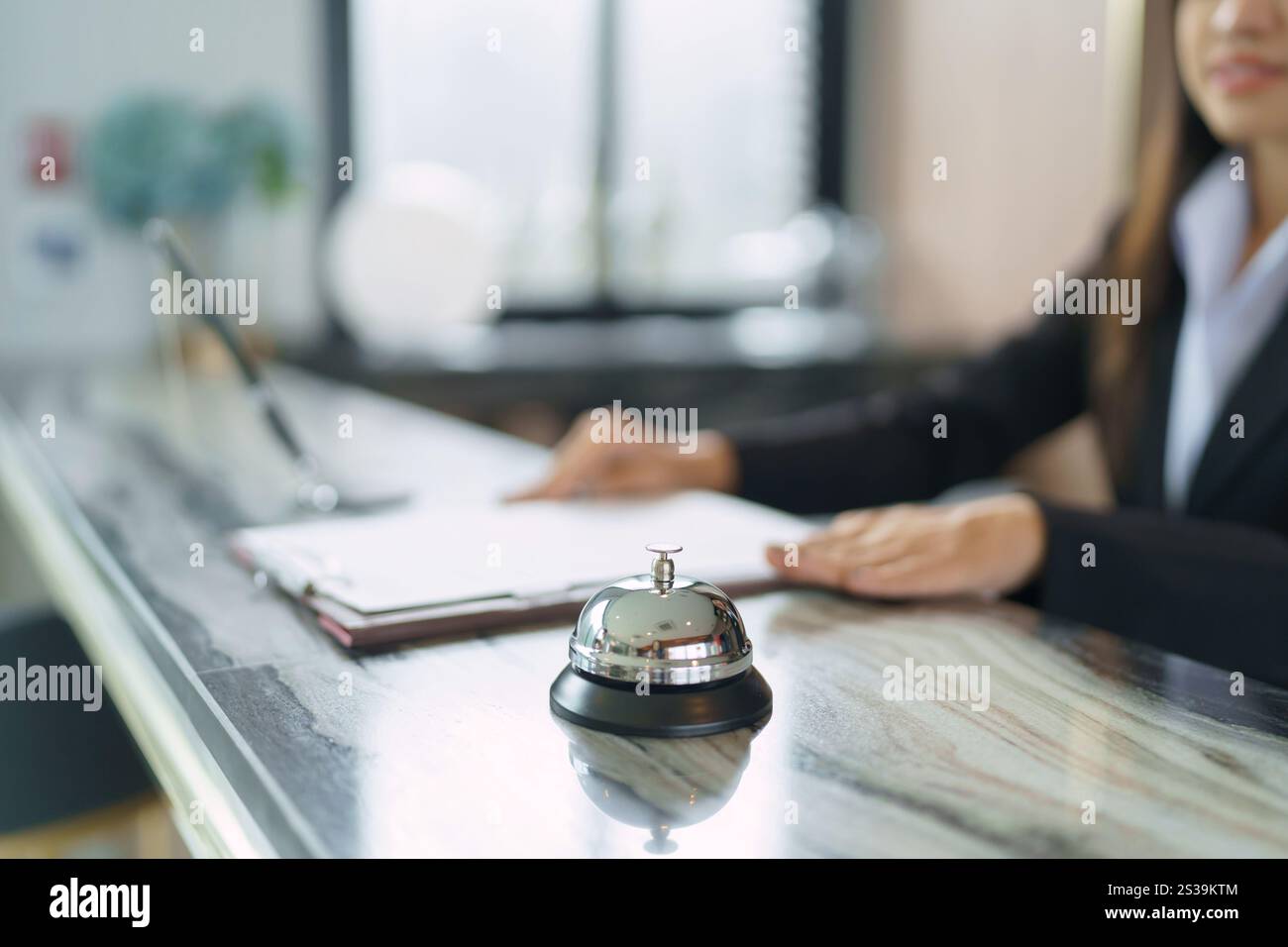 Hotel receptionist in uniforms at desk in lobby Friendly and welcome ...