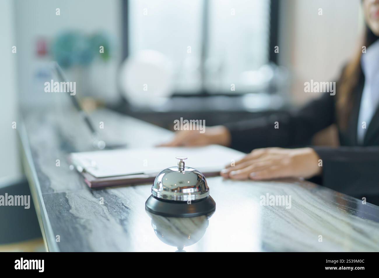 Hotel receptionist in uniforms at desk in lobby Friendly and welcome ...