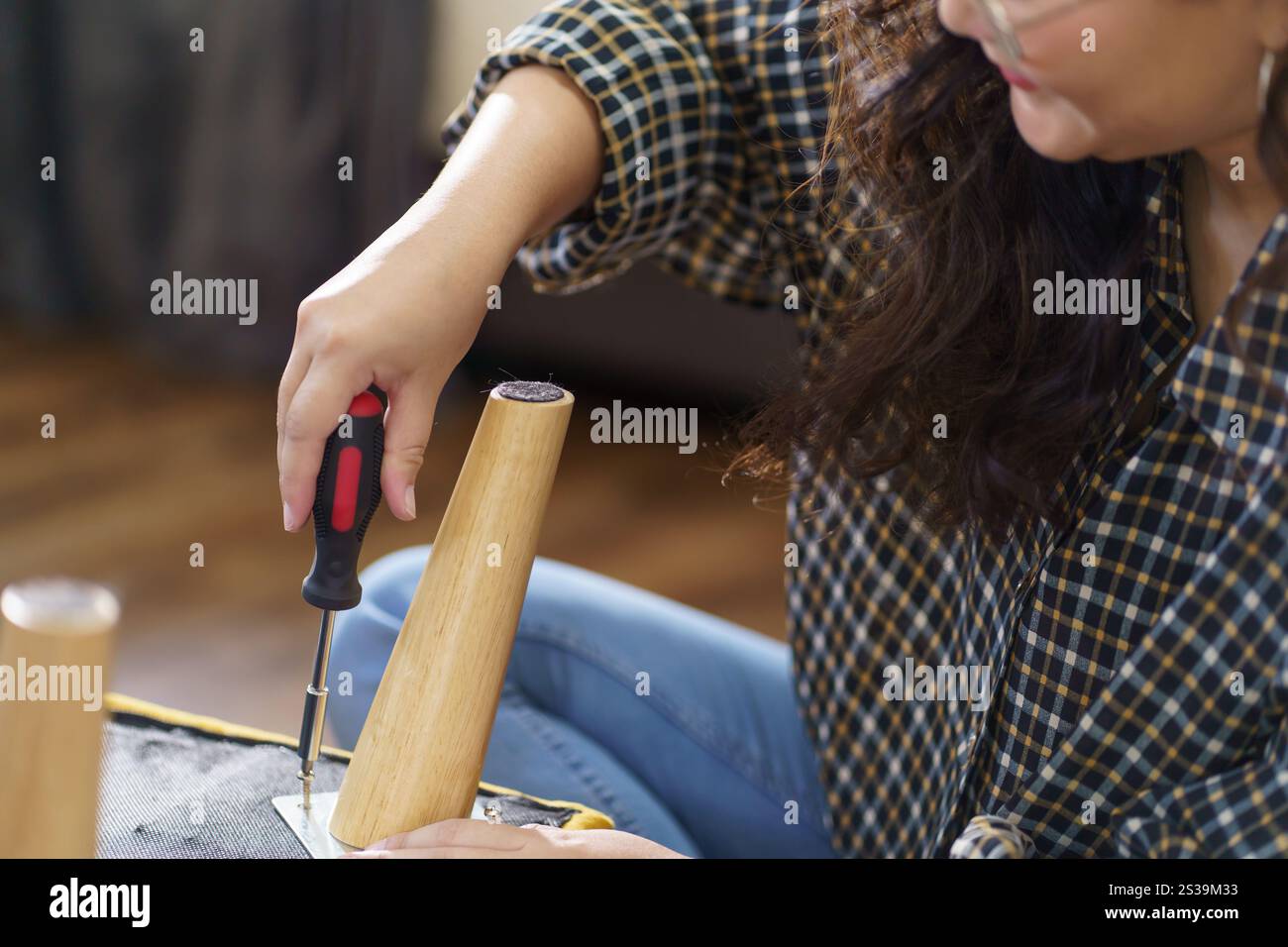 Asian Woman self repairs furniture renovation using equipment to diy ...