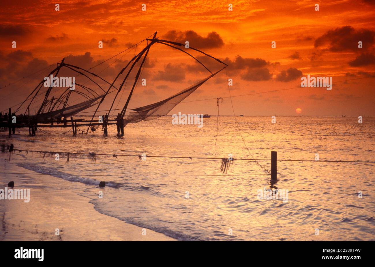the Chinese Fishing Net by sunset at the Coast in the city of Kochi or ...