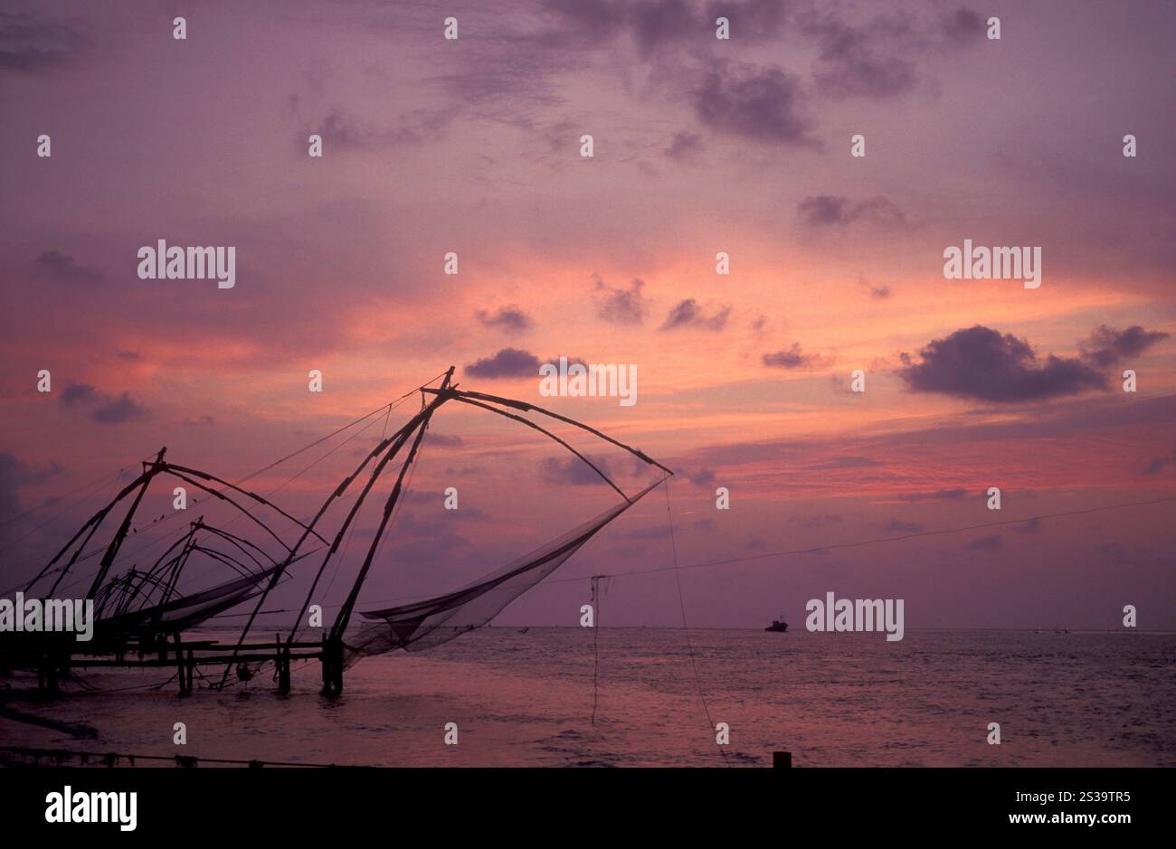 the Chinese Fishing Net by sunset at the Coast in the city of Kochi or ...