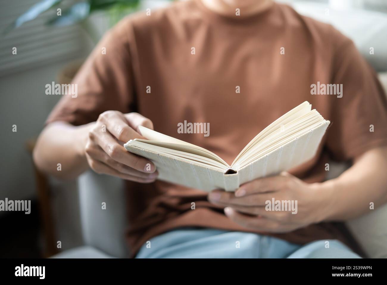 Men reading book and relaxing at home and comfort in front of opened ...