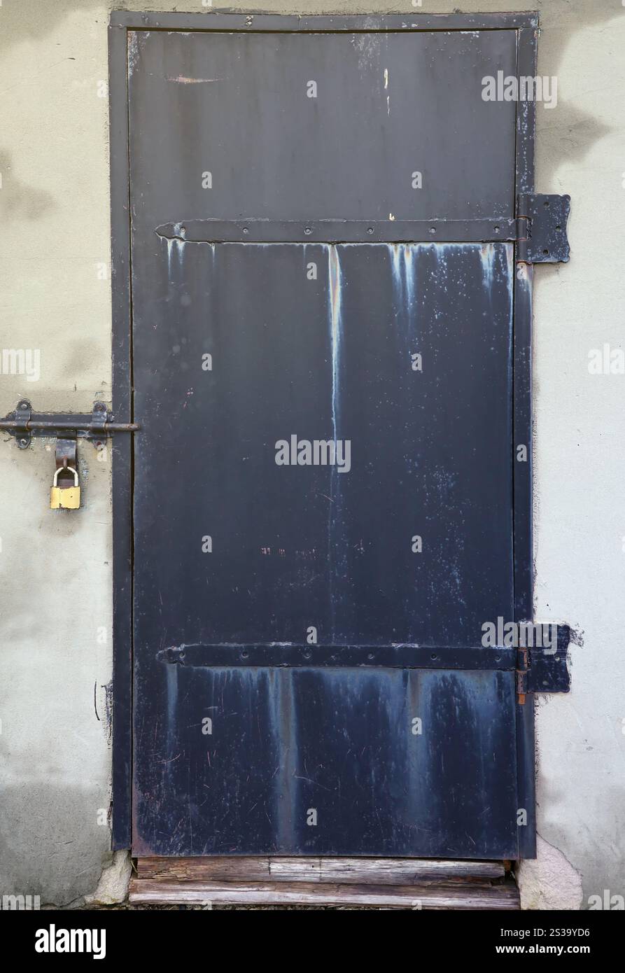 Black old metal door texture with iron handle and concrete wall ...