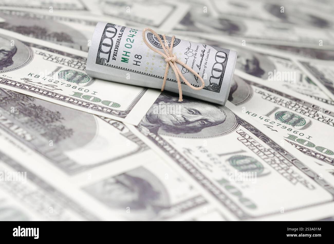 US dollars rolled up and tightened with band lies on a lot of american ...