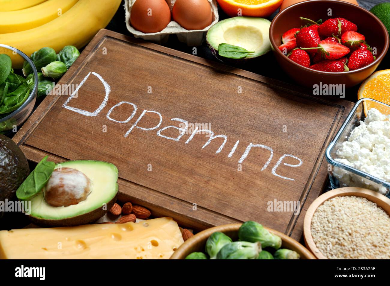 Wooden board with word Dopamine and different products as background ...