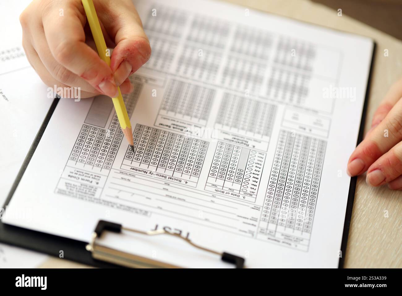 Female student hands testing in exercise and taking fill in exam paper ...
