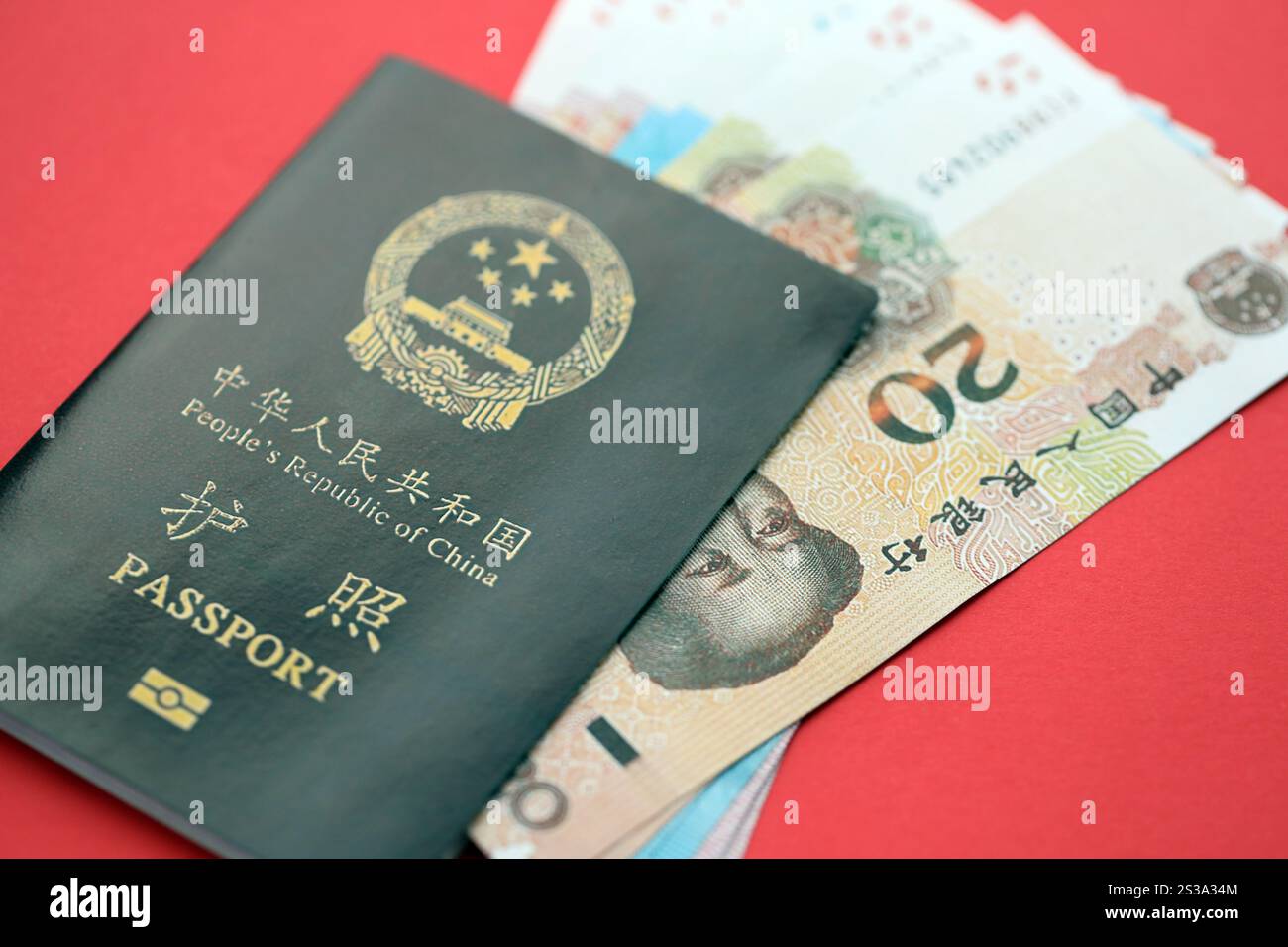 Red passport of People Republic of China and chinese yuan money bills ...