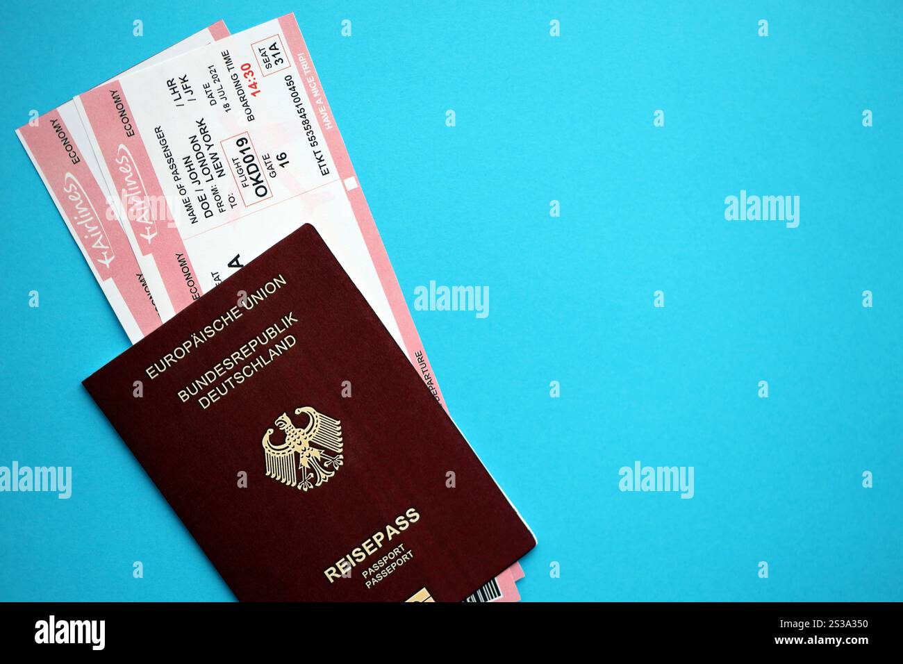 Red German passport of European Union with airline tickets on blue ...