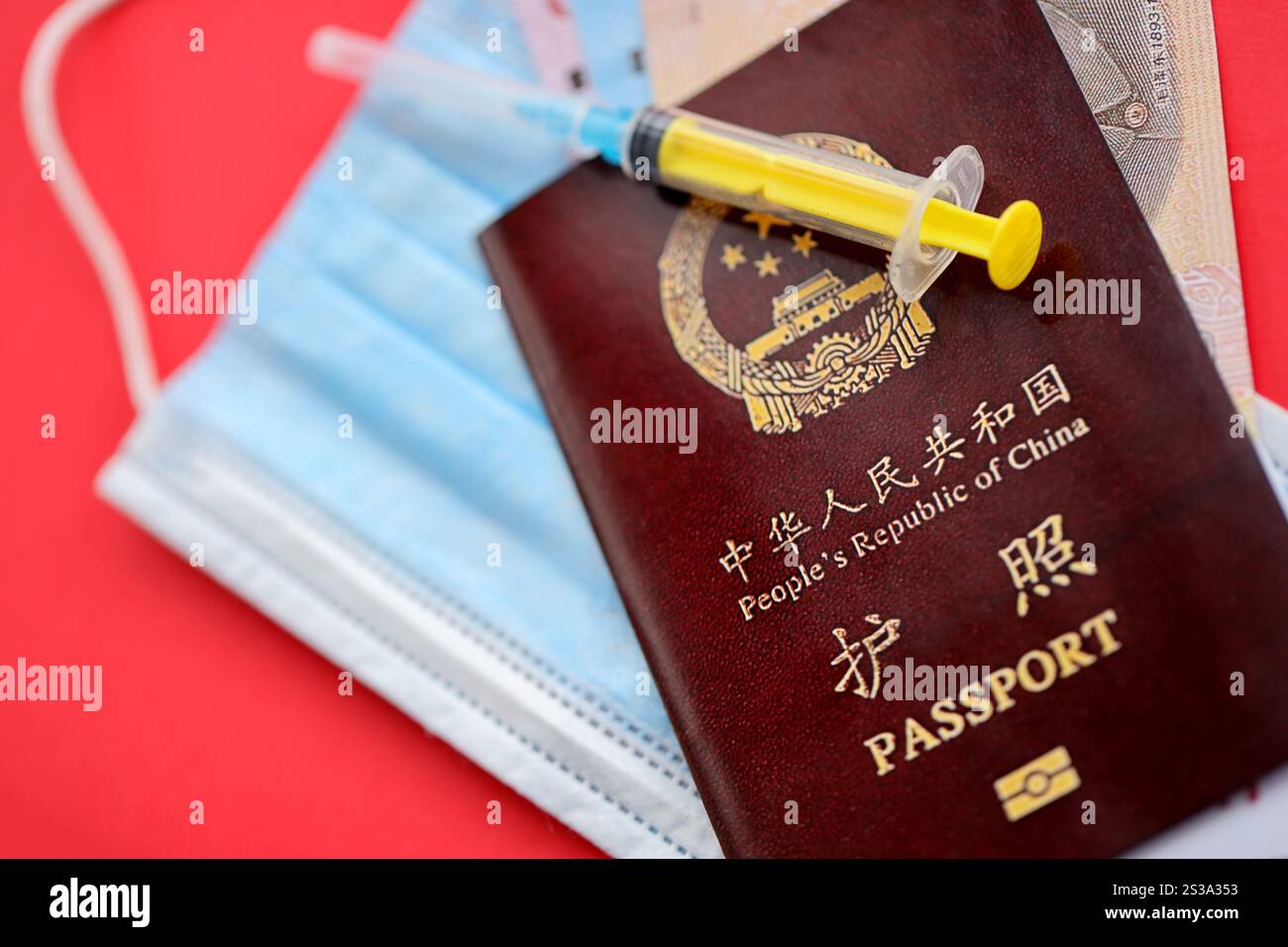 Red passport of People Republic of China and chinese yuan money bills ...