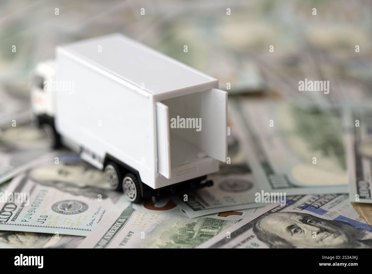 Delivery truck on hundred dollar bills banknotes. Background of moving ...