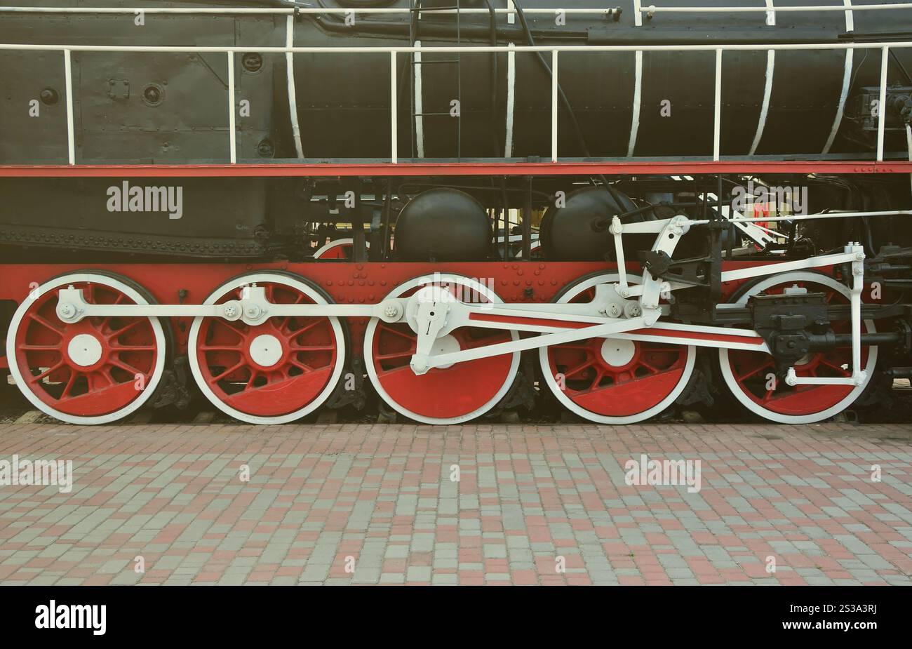 Wheels of the old black steam locomotive of Soviet times. The side of ...