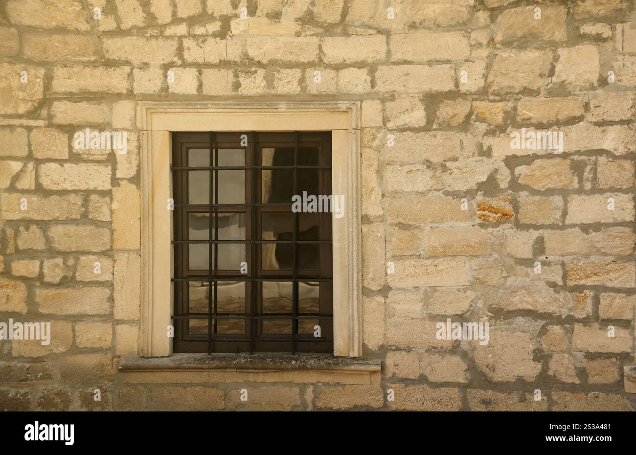 Very old window in brick stone wall of castle or fortress of 18th ...
