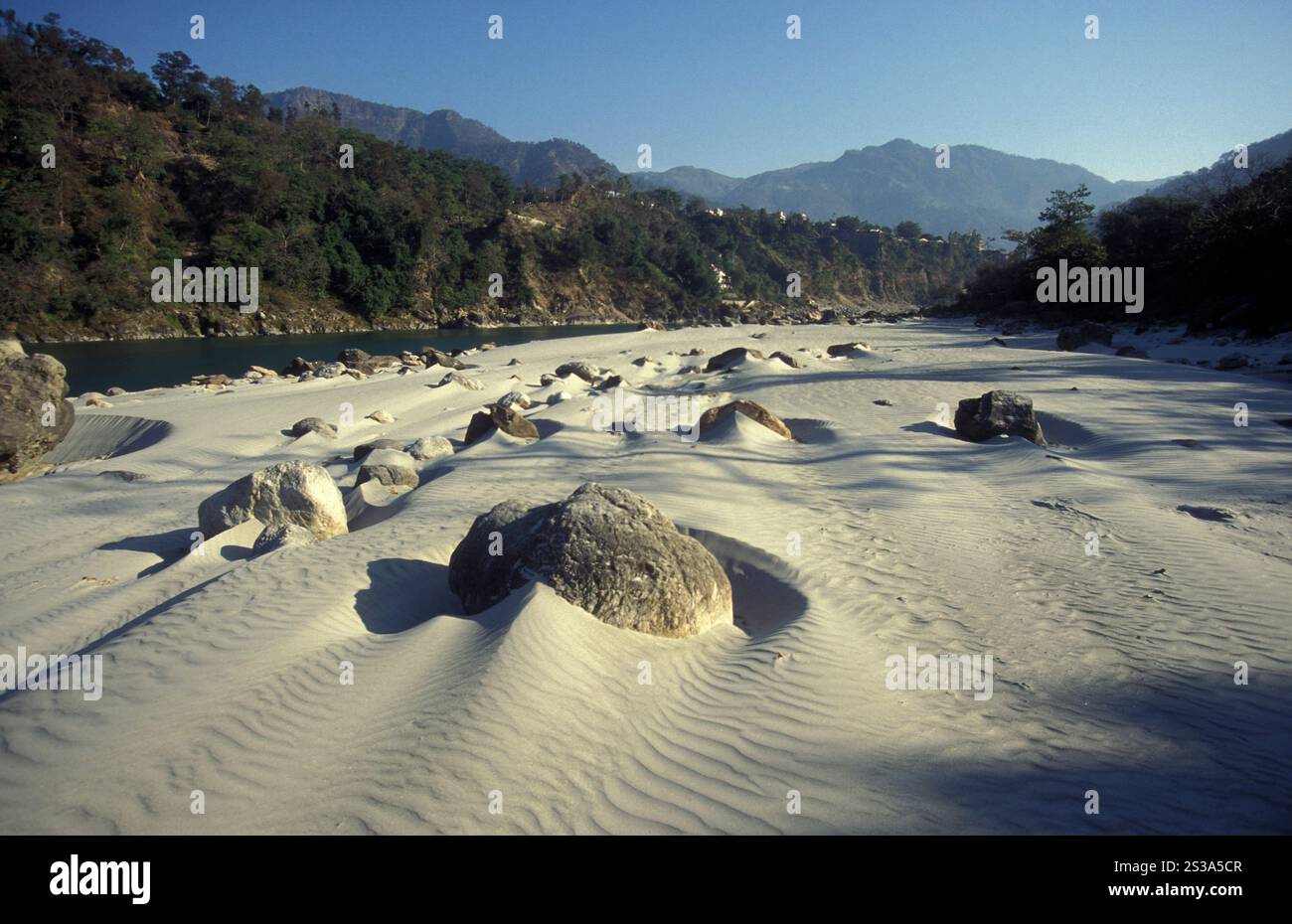 a sand dunes and Beach at the Holy Ganges River with the city of ...