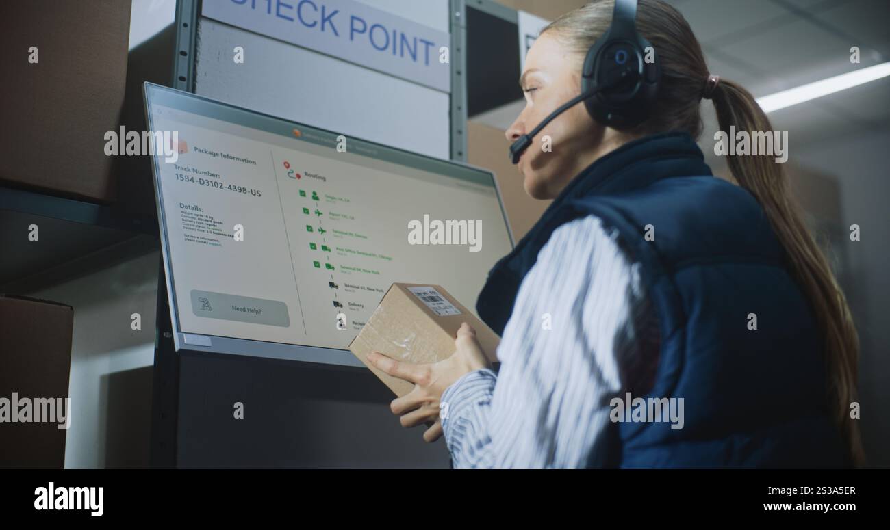 Female Warehouse Employee Wearing Headset Scans Cardboard Box at Postal ...