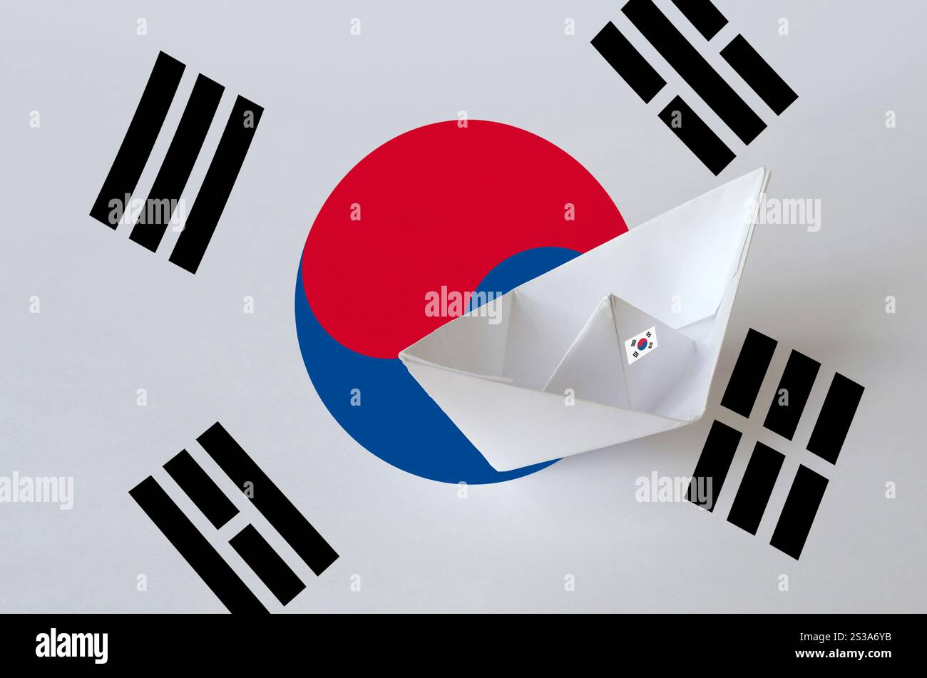 South Korea flag depicted on paper origami ship closeup. Oriental ...
