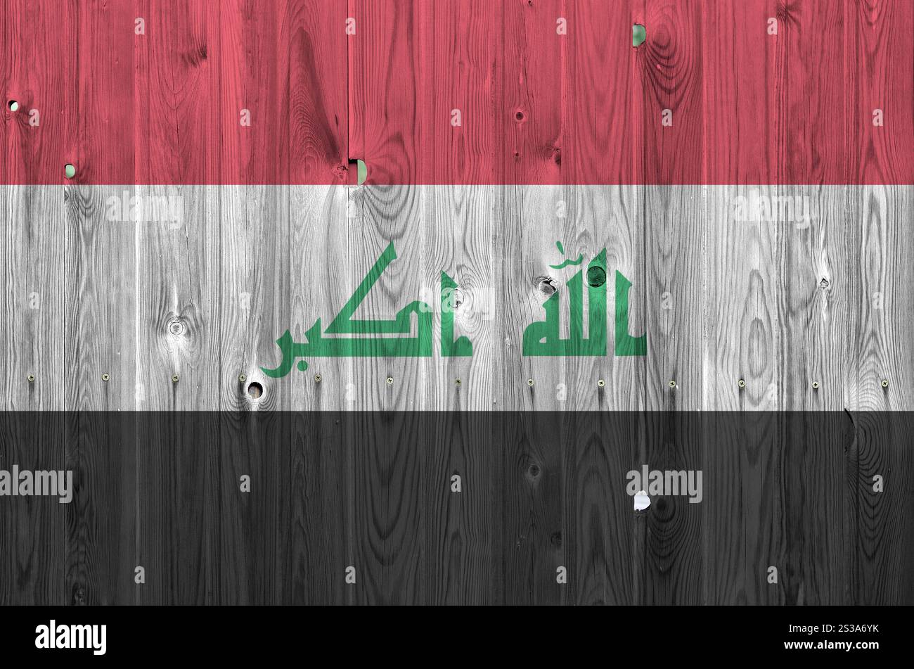 Iraq flag depicted in bright paint colors on old wooden wall close up ...