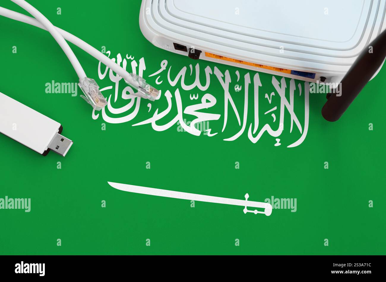 Saudi Arabia flag depicted on table with internet rj45 cable, wireless ...
