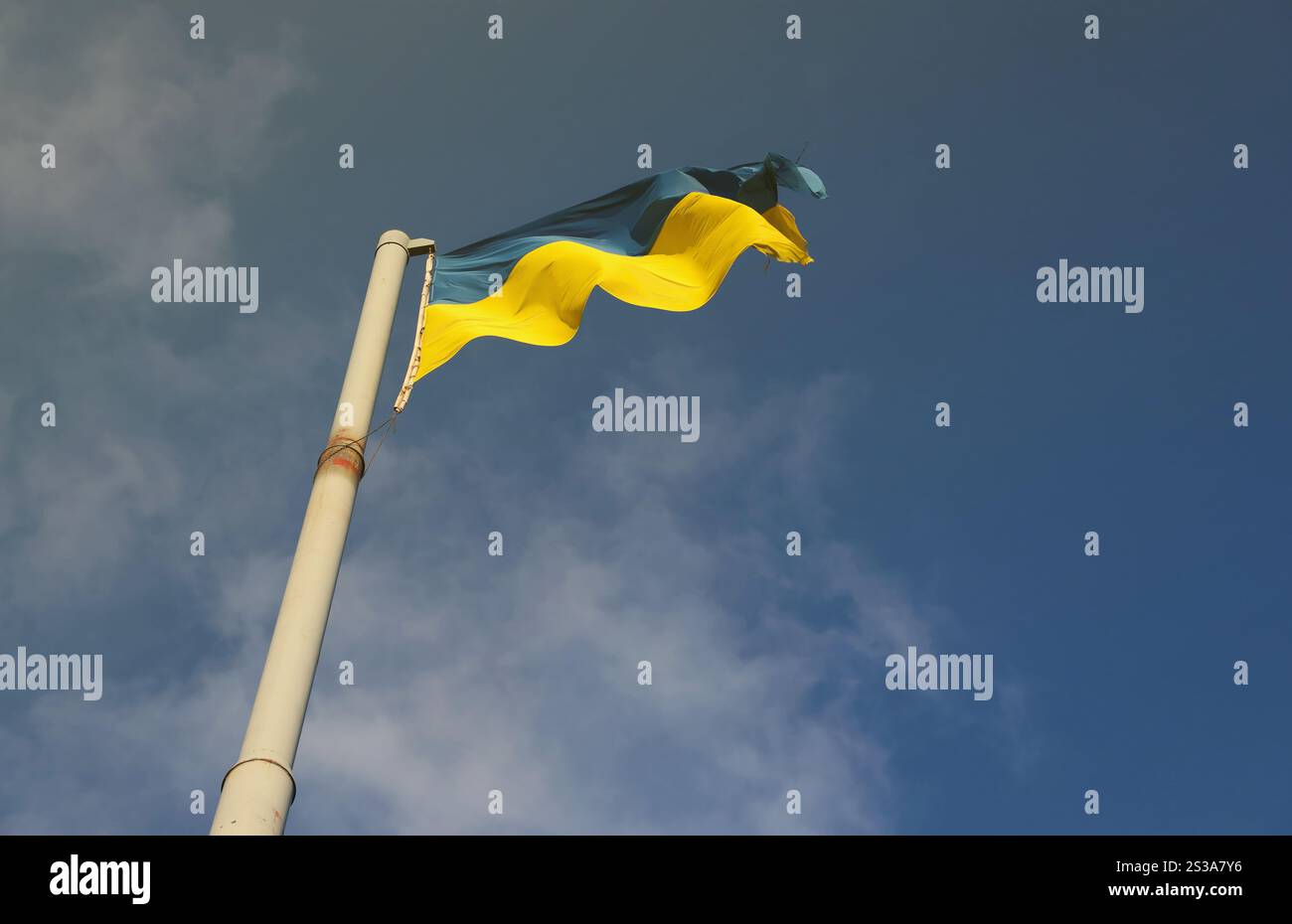 Ukraine flag large national symbol fluttering in blue sky. Large yellow ...