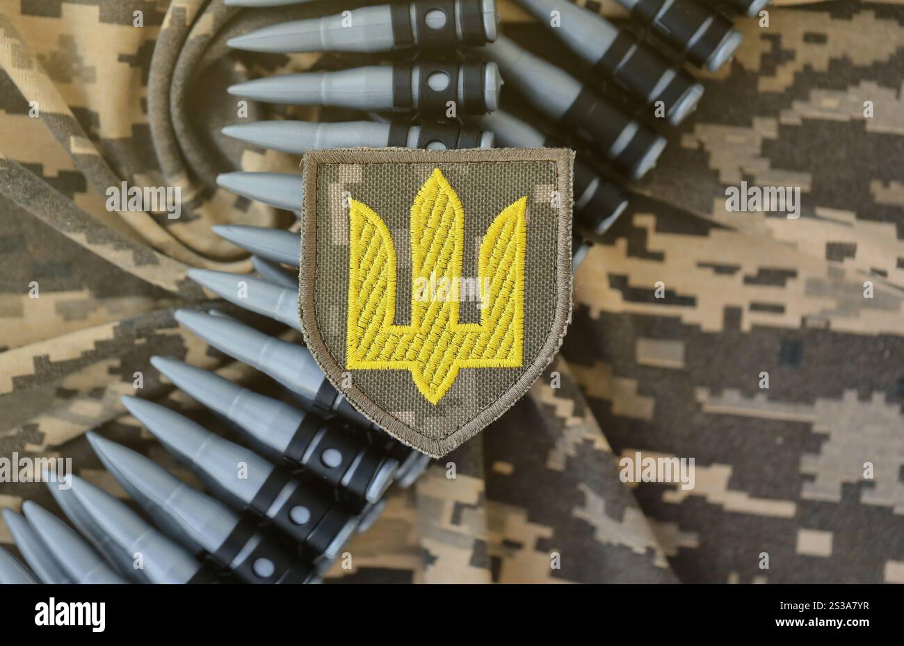 Ukrainian army symbol on machine gun belt lies on ukrainian pixeled ...