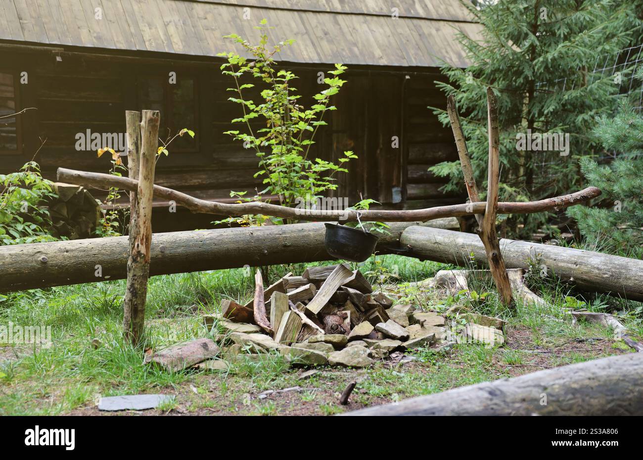Tourist pot hanging over the fire on a tripod. Cooking in the campaign ...