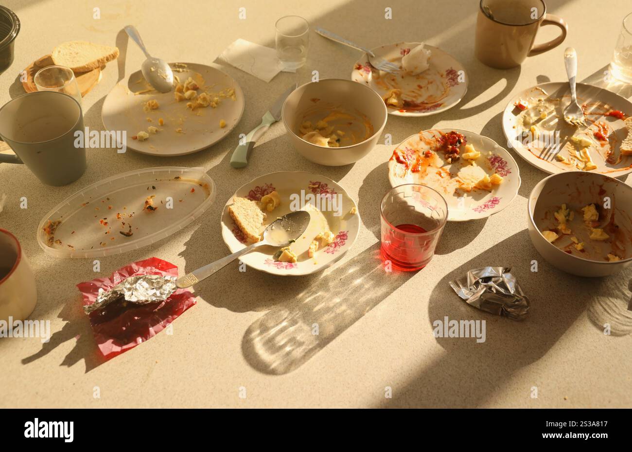 Empty dirty plates with spoons and forks on the table after meal ...