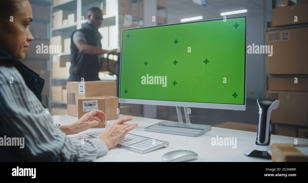 Distribution Center: Female Logistics Specialist Works on Computer in Warehouse Facility, Enters ...