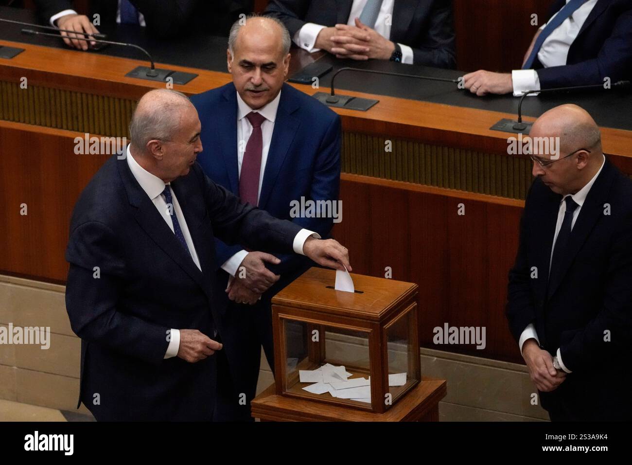 A Lebanese lawmaker, left, casts his vote to elect a new president, at ...