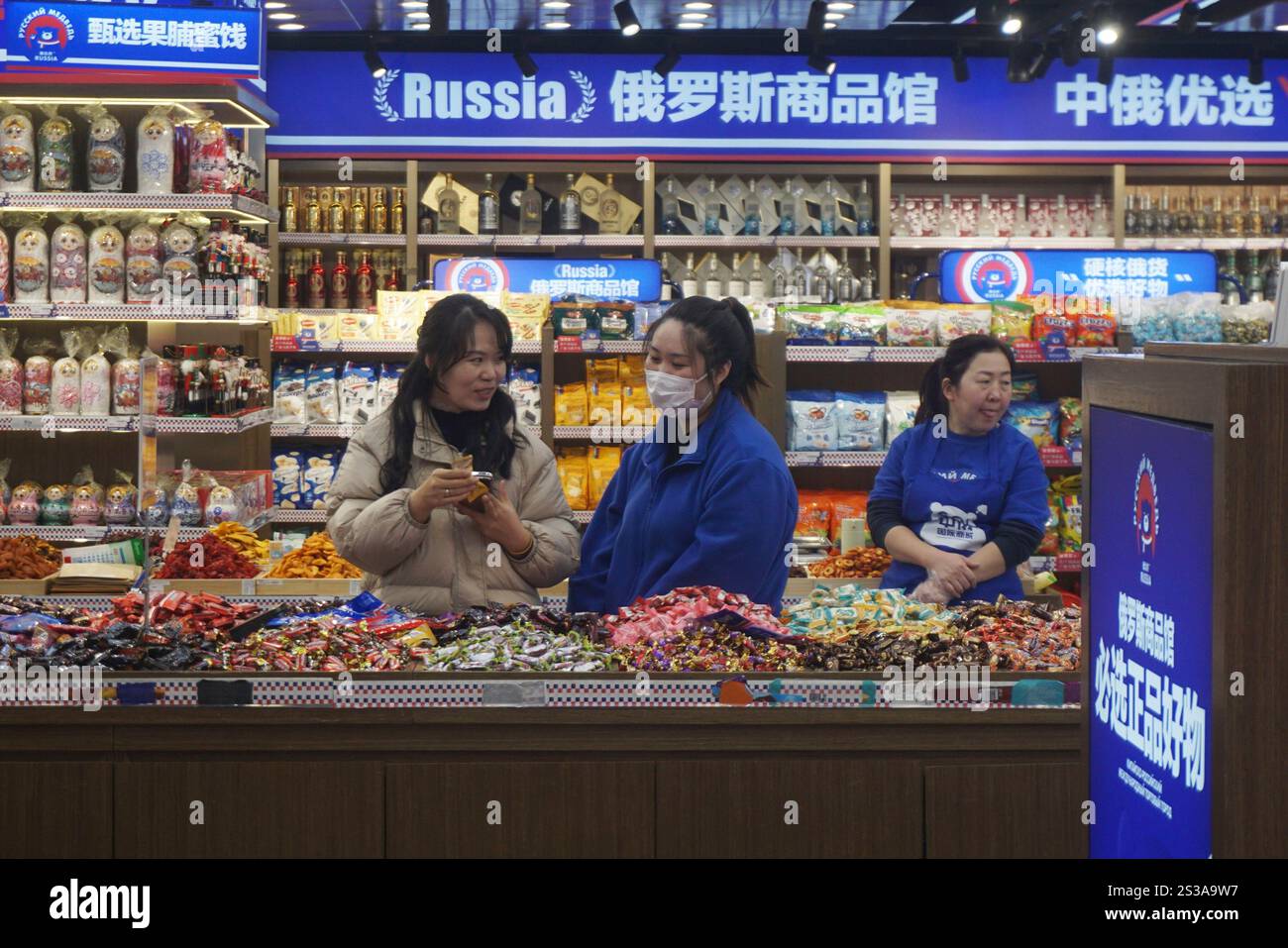 A woman shops in a store of food products from Russia or Sino-Russian ...