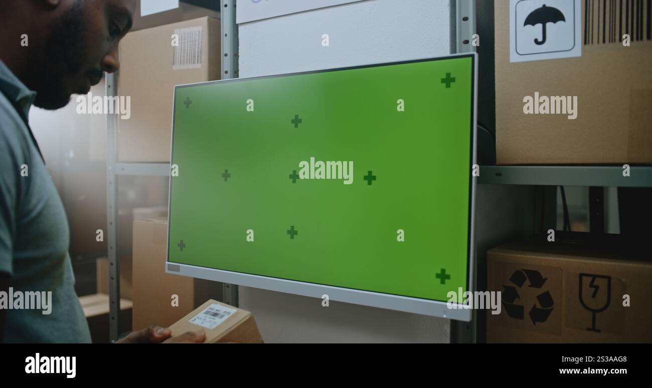 Warehouse Facility: African American Inventory Manager Scans Code on ...