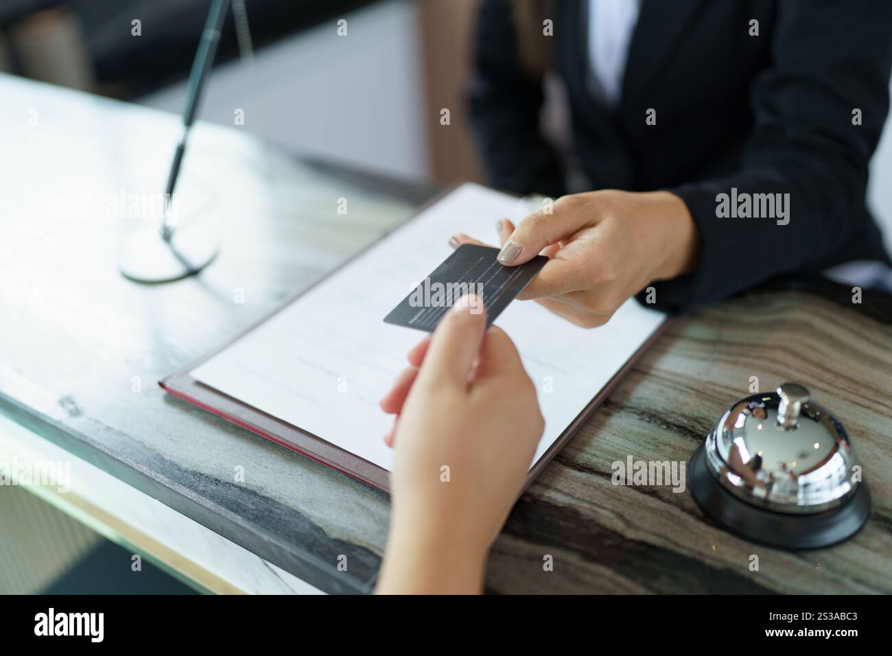 Hotel receptionist in uniforms Concierge giving the key doing check-in ...