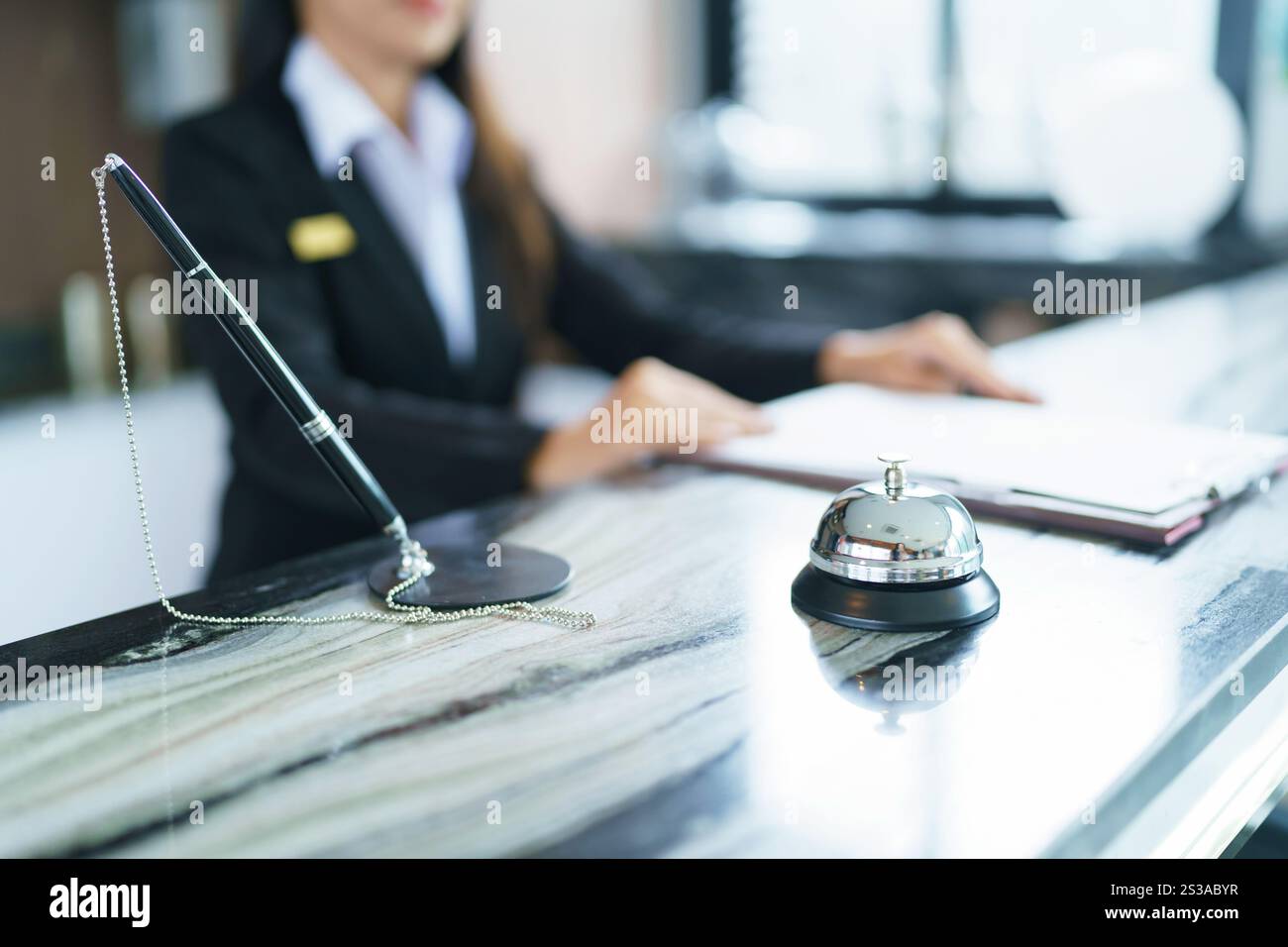 Hotel receptionist in uniforms at desk in lobby Friendly and welcome ...