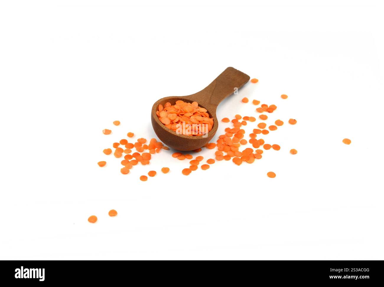 Red lentils in a wooden spoon isolated on white background. Red lentils pile isolated. Dry ...