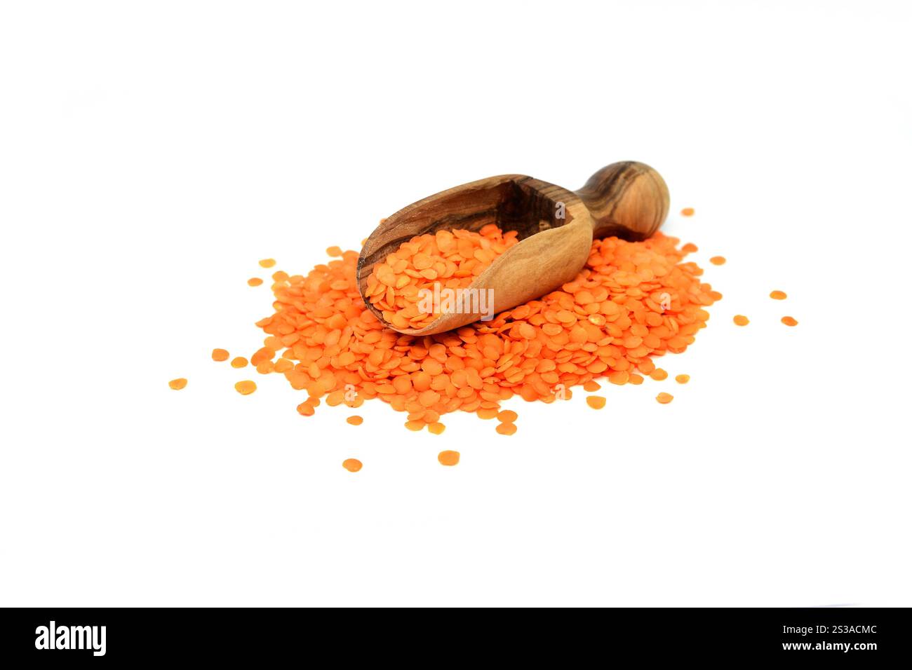 Red lentils in a wooden scoop isolated on white background. Red lentils pile isolated. Dry ...