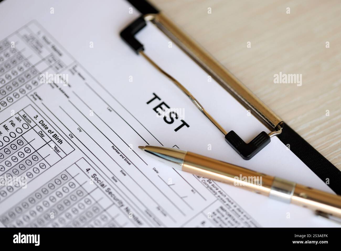 Blank educational test for students lies on table in classroom with pen ...