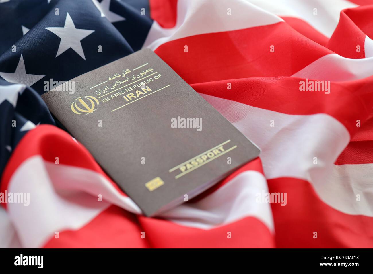 Red Islamic Republic of Iran passport on United States national flag ...