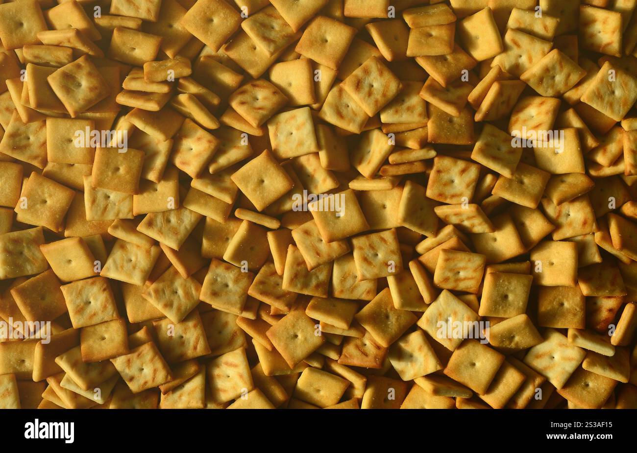 Background texture of small edible squares baked from dough and ...