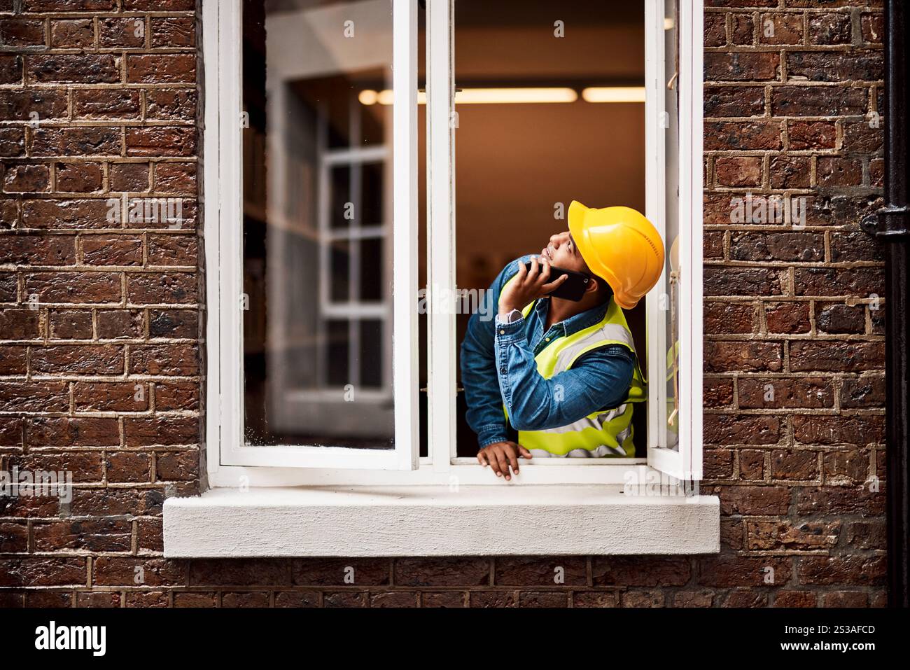 Man, engineer and talk with phone call by window of inspection ...