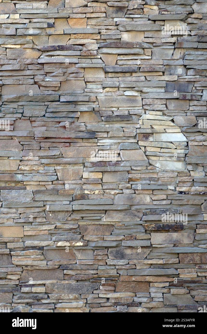 Modern pattern of flatten stone wall decorative surfaces in brown color. Stone lined with ...