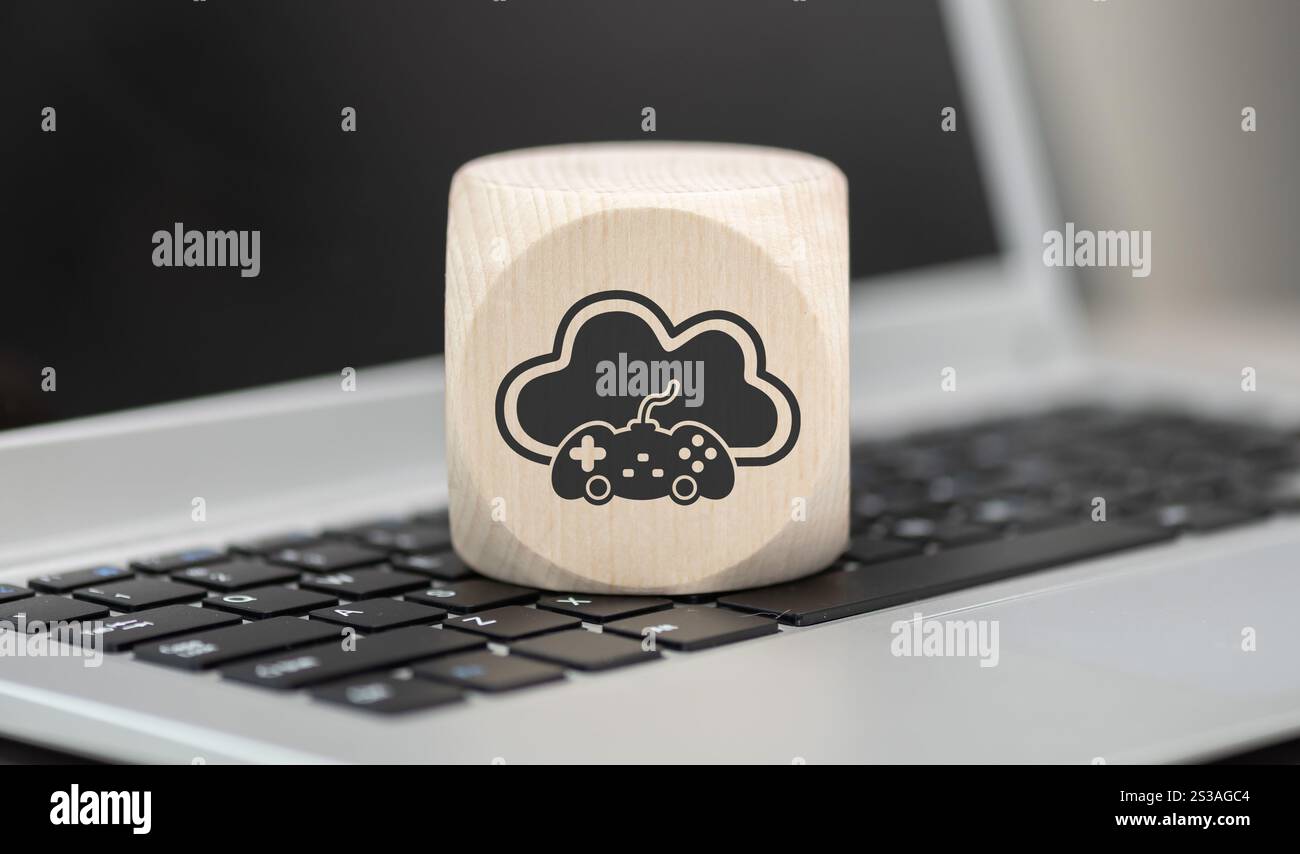 Wooden block with symbol of cloud gaming concept on laptop keyboard ...