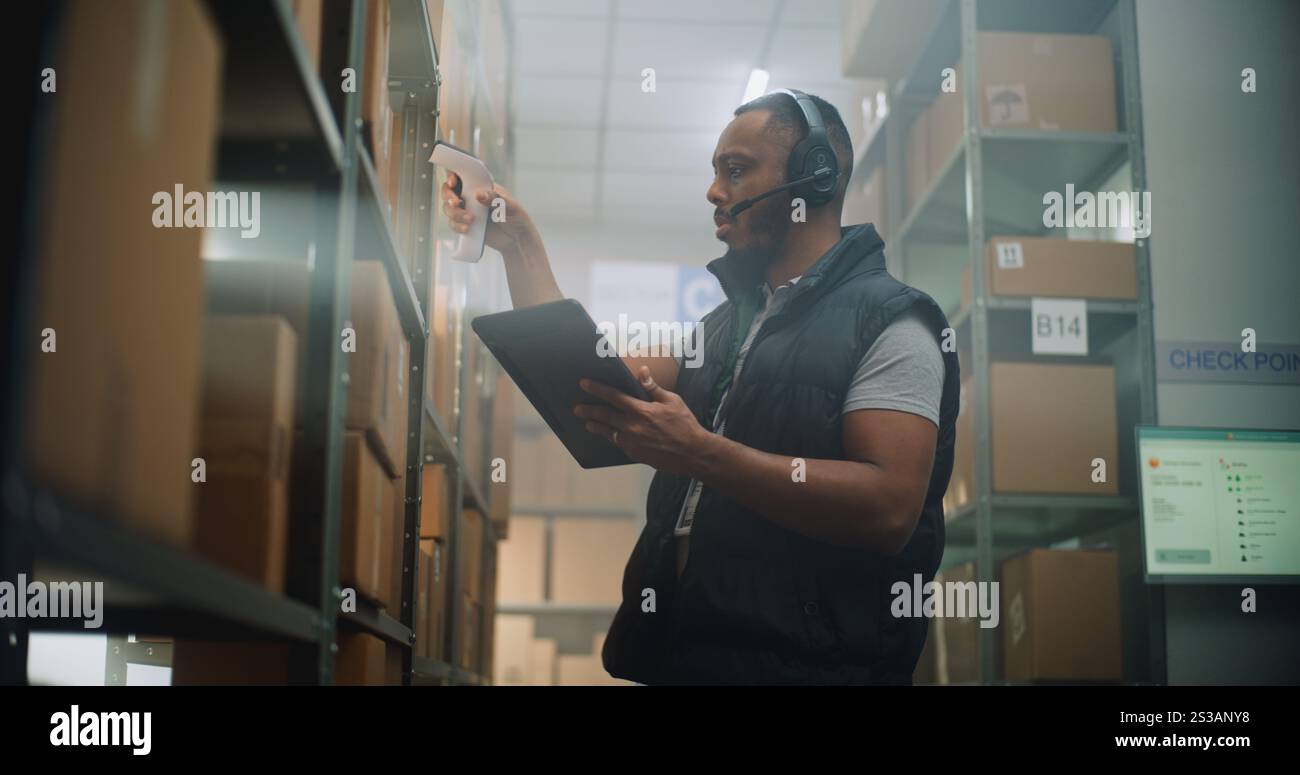 African American Inventory Manager in Headset Scans Cardboard Box with E-Commerce Online Orders ...