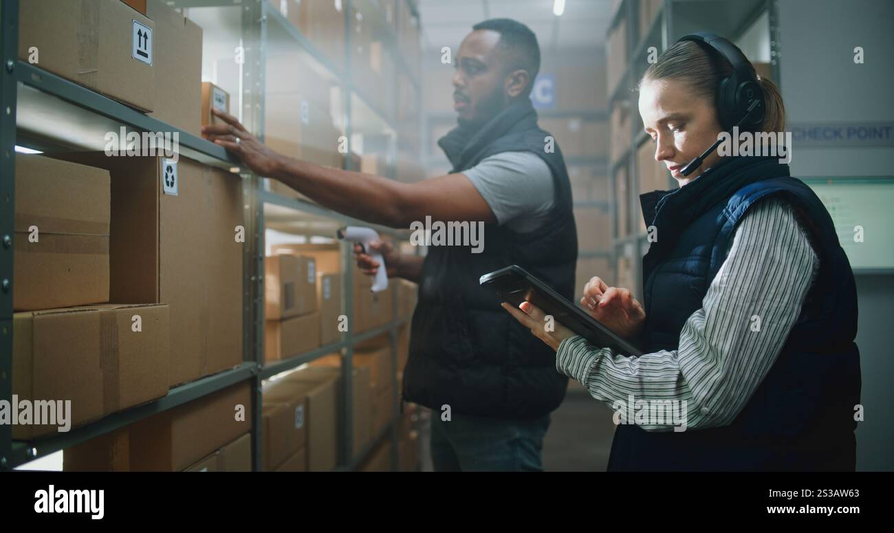 African American Employee Scans Parcels with E-Commerce Goods with Scanner. Female Warehouse ...