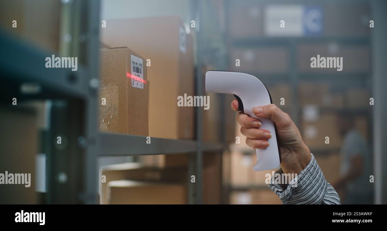 Close Up of Warehouse Employee Scanning Cardboard Box with E-Commerce ...