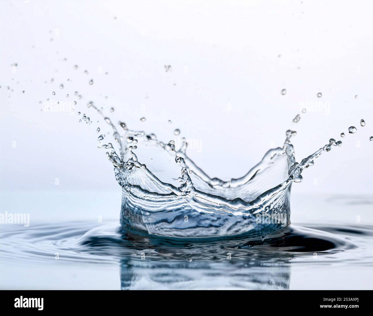 A dynamic splash of clear water exhibits fluid movement as droplets ...