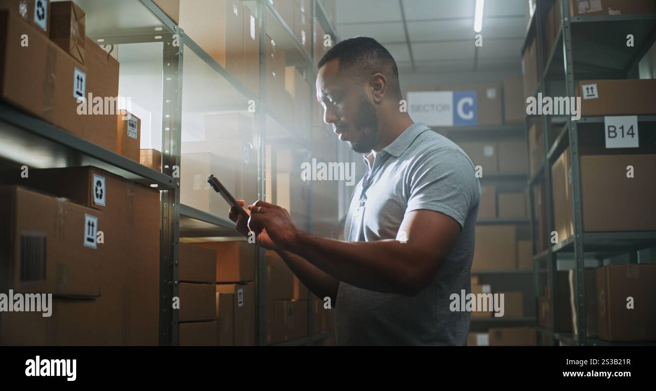 African American Sorting Center Employee Scans Cardboard Box with E-Commerce Order in Warehouse ...