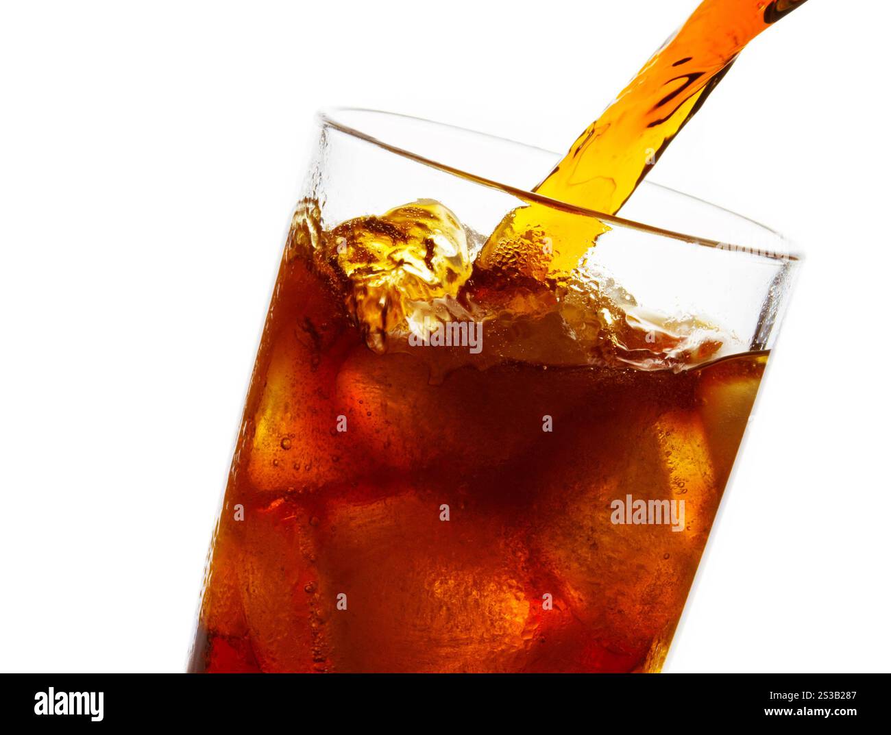 Cola is pouring into glass on white background. Cola is pouring into ...
