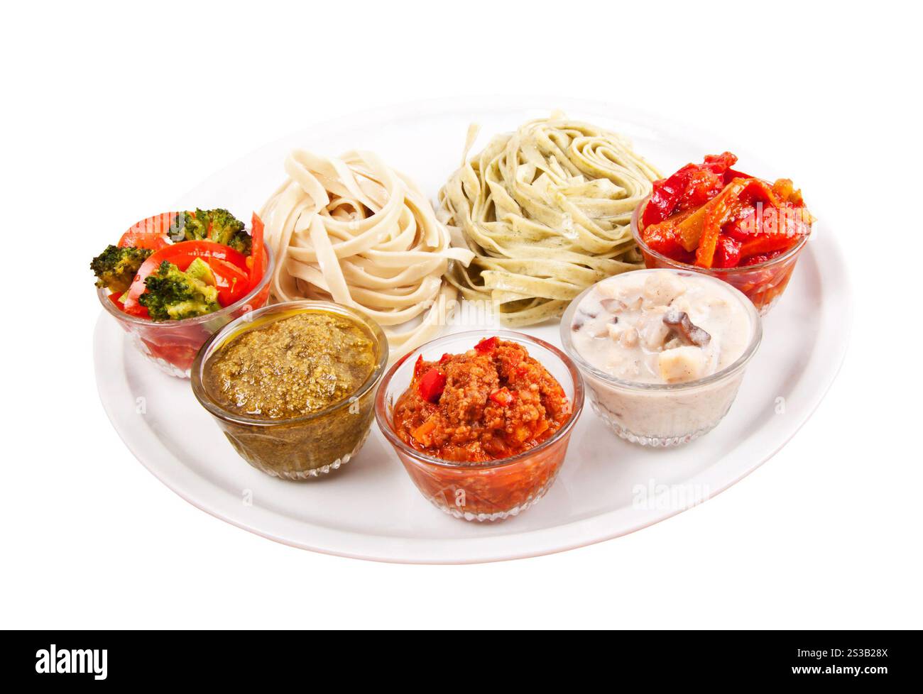 two choices of pasta and various spices on plate. two italian ...