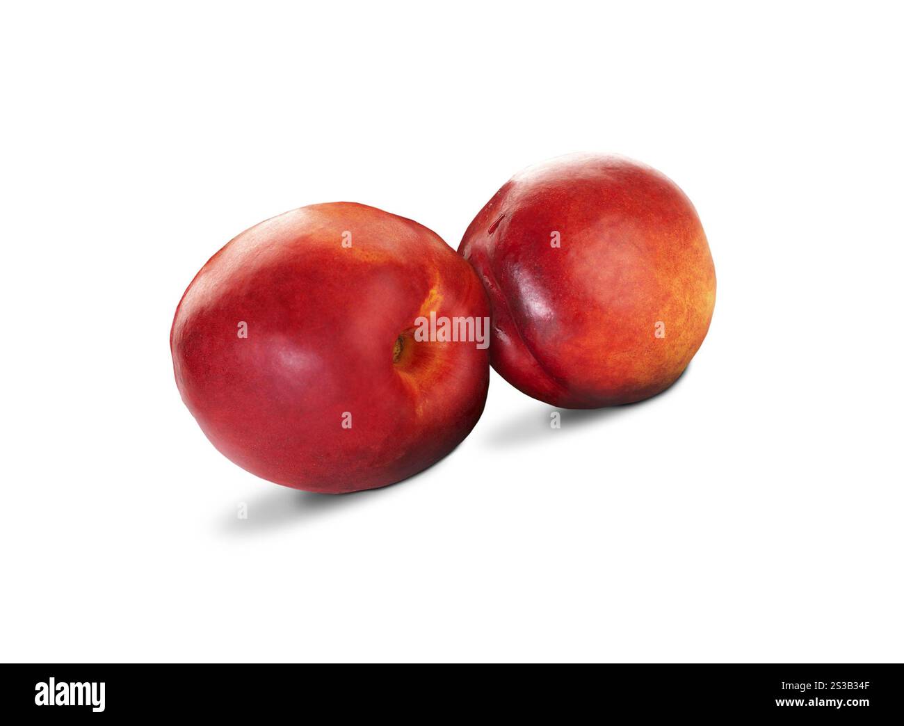 two nectarines with green leaves over white background. two apples ...