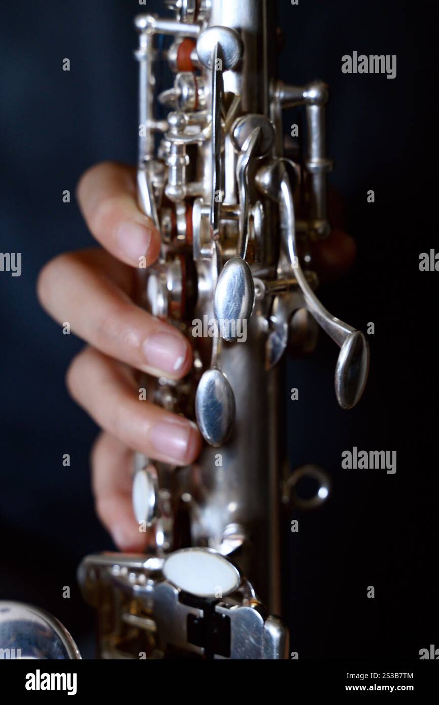 Hands playing a silver saxophone Stock Photo - Alamy