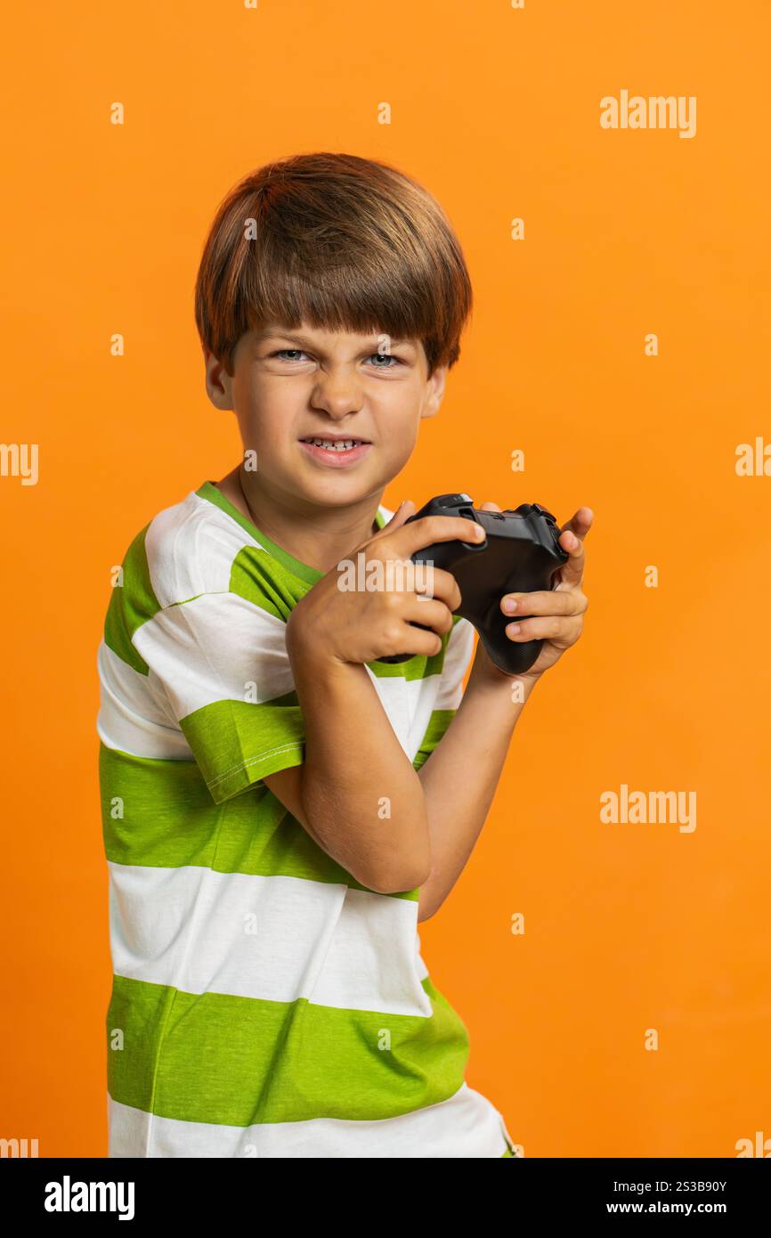 Young preteen child boy kid using joystick controller playing video ...