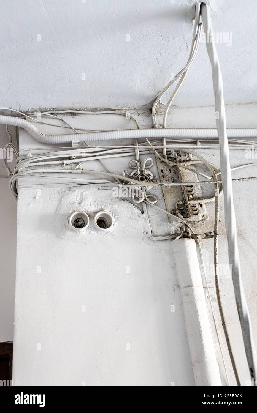 chaotic electrical wiring on wall in hall of residential building Stock ...